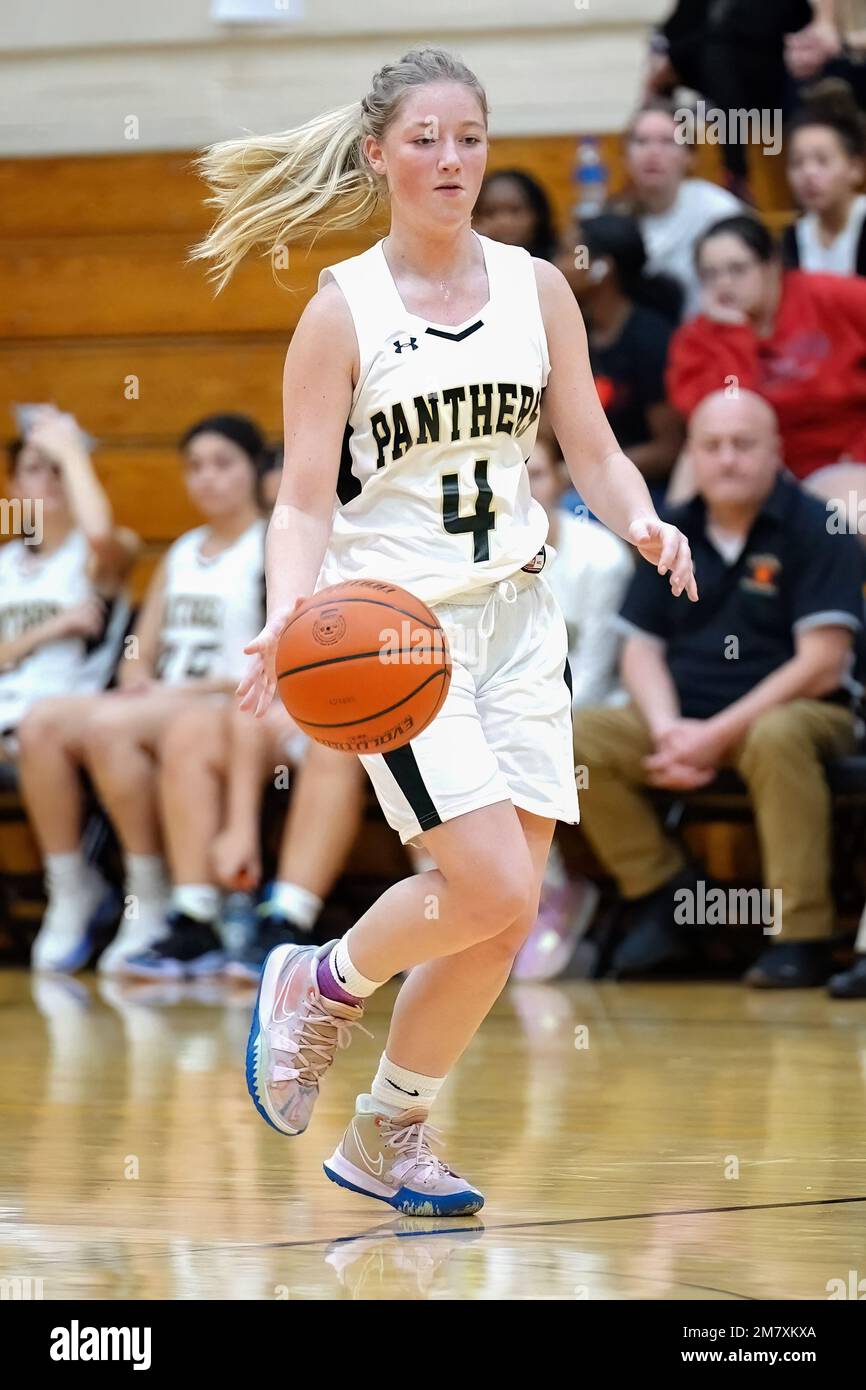 A vertical shot of a young female player on a court at a girls fall ...