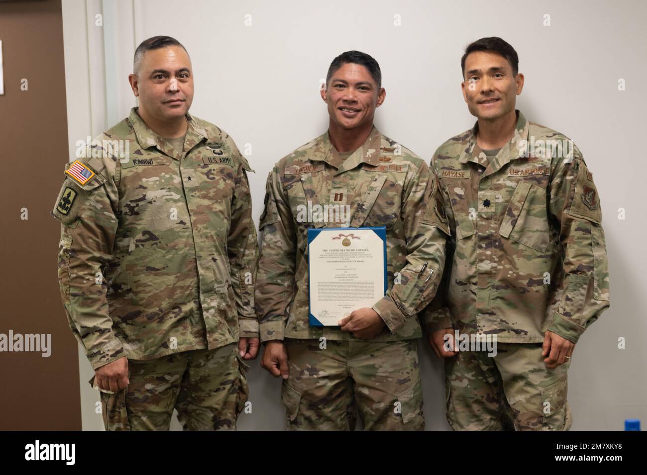 U.S. Air Force Capt. Elijah Lincoln (center) is awarded an achievement ...