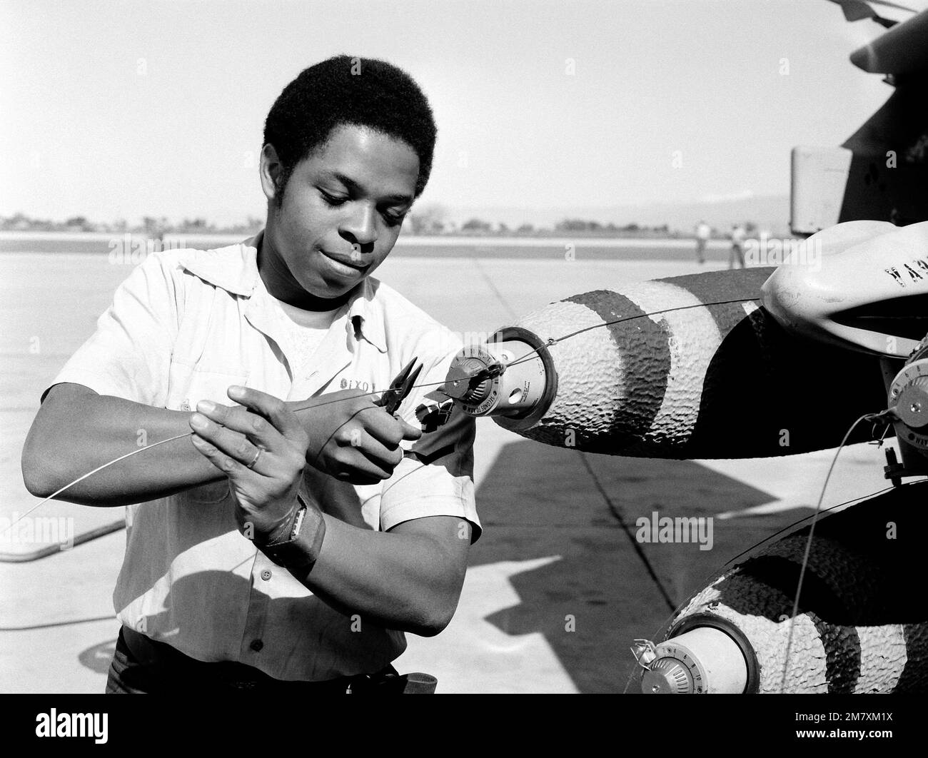 An Ordnancemen from Carrier Air Wing 15 (CVW-15) arms a bomb being ...