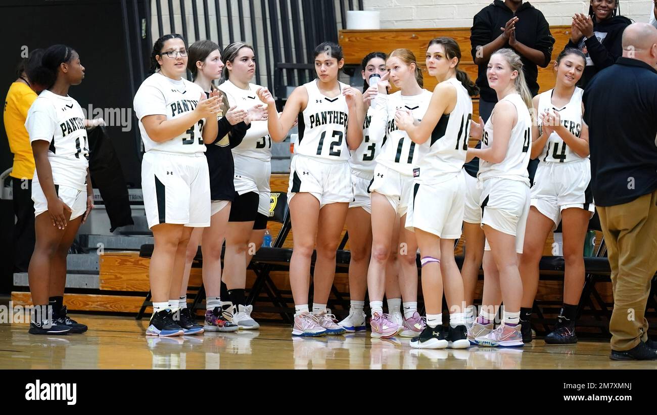 A young female team getting ready on an indoor court at a girls fall ...