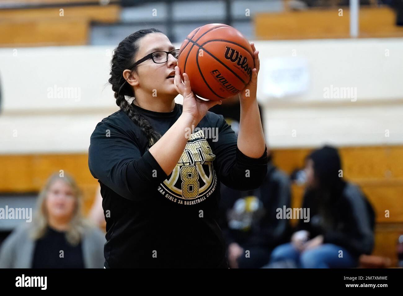 A young female player on an indoor court at a girls fall high school ...