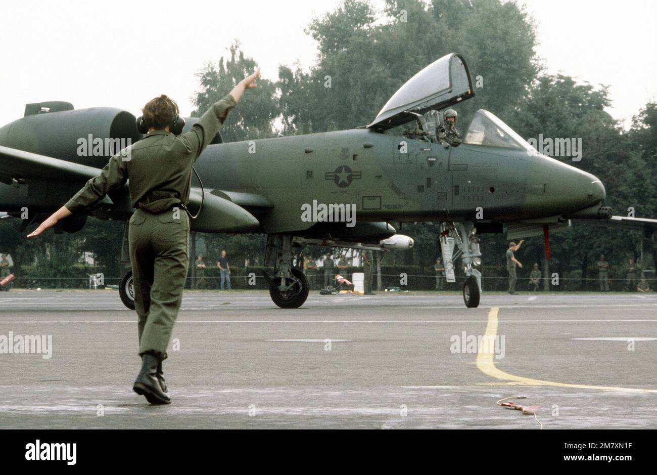 An A-10A Thunderbolt aircraft is maneuvered from its parked position ...