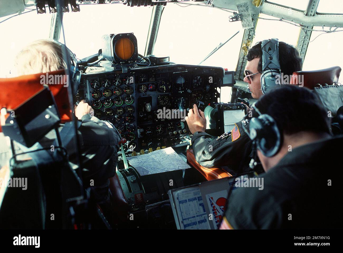 The flight crew, in the cockpit of a C-141 Starlifter aircraft ...