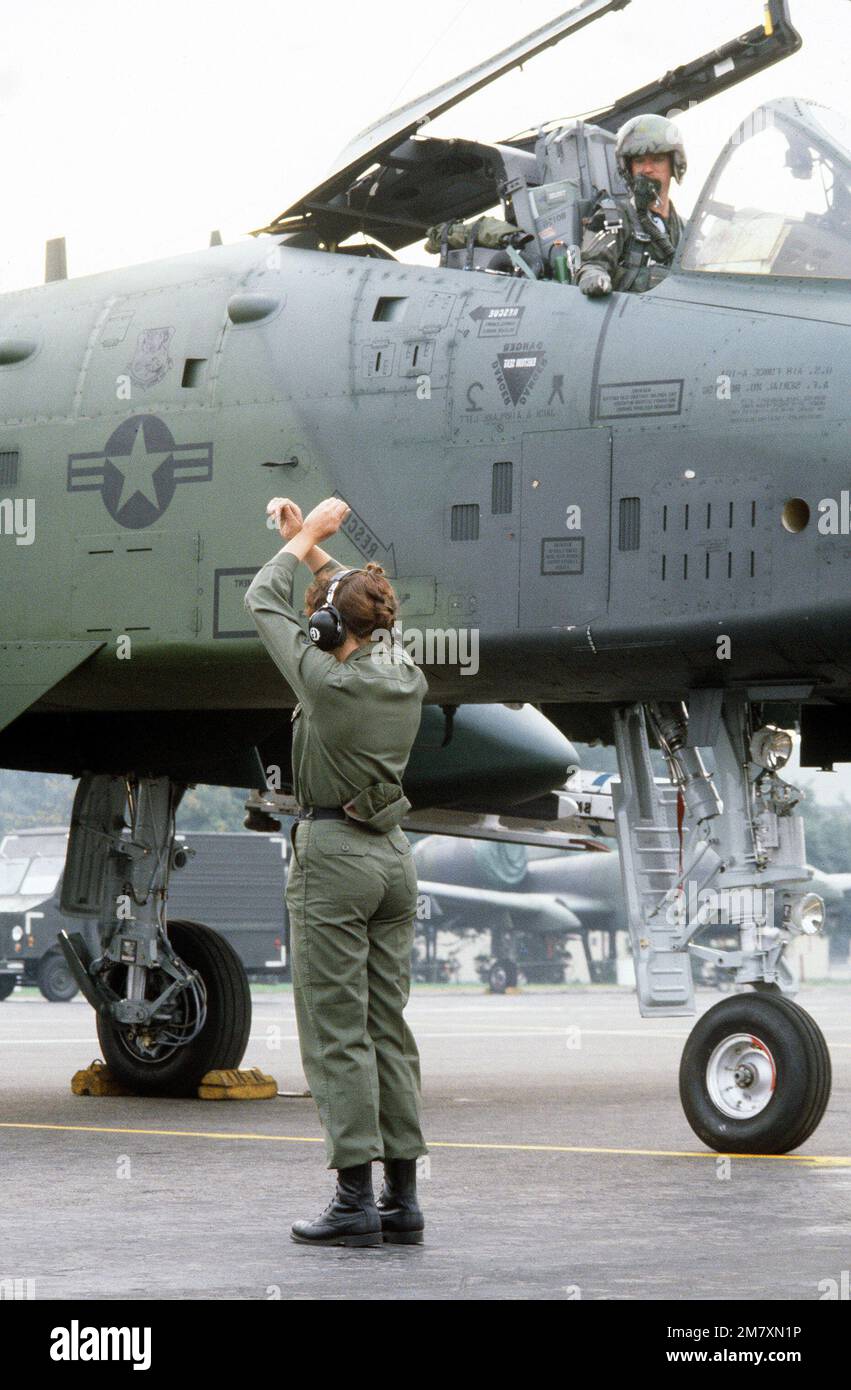 An A-10A Thunderbolt aircraft is maneuvered from its parked position ...