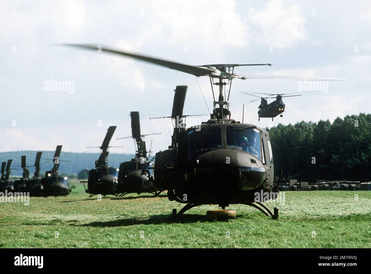 A line of UH-1N Iroquois helicopter are parked during Exercise Reforger ...