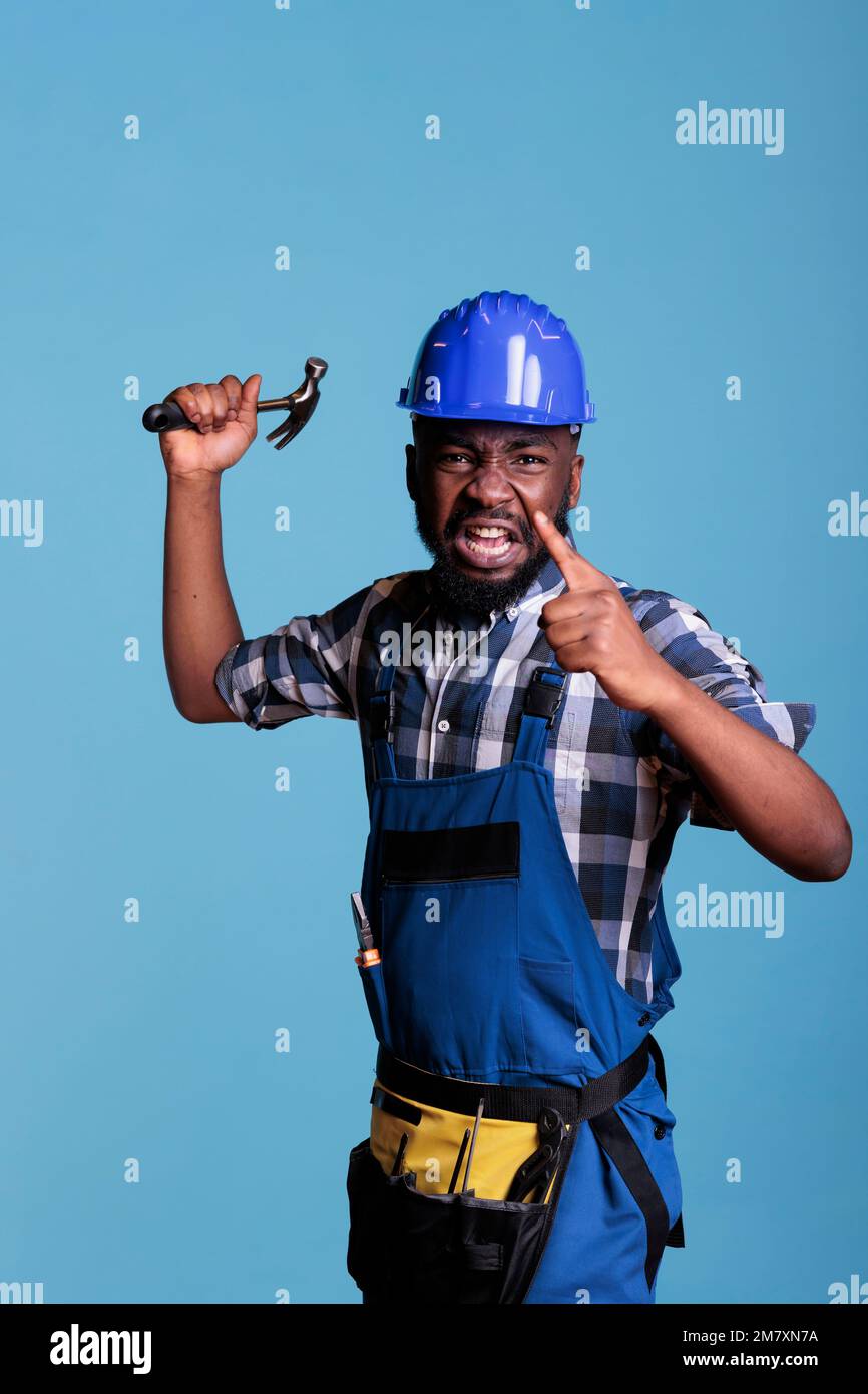 Angry construction worker angry and upset about overwork and long hours ...