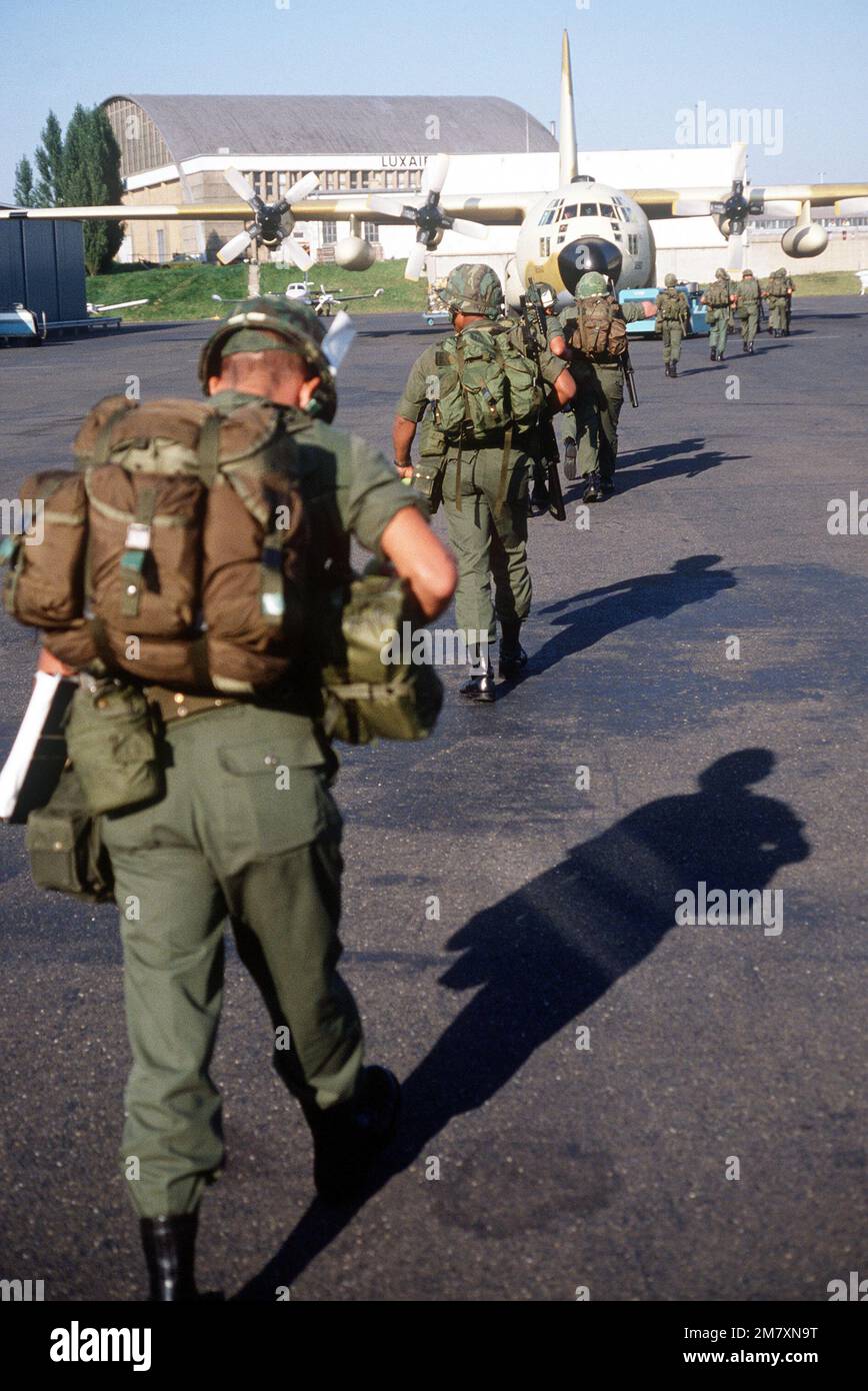 Paratroopers prepare to board a C-130 Hercules aircraft prior to a ...