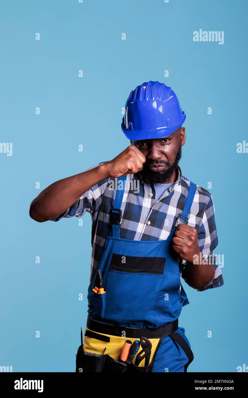 Aggressive handyman wearing coveralls trying to fight on camera ...