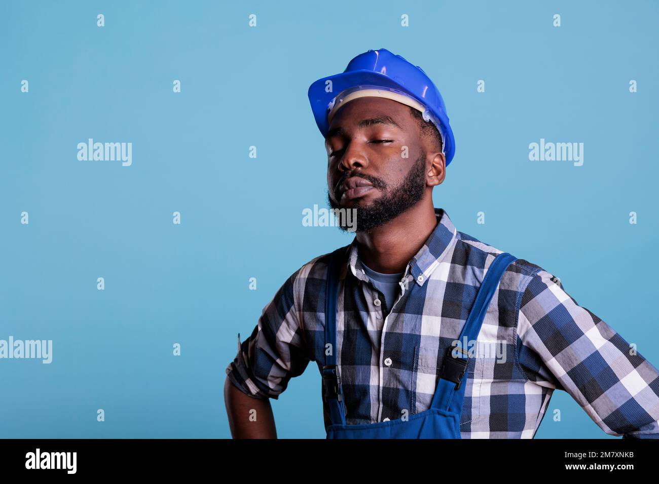 Tired exhausted construction worker in construction helmet and ...