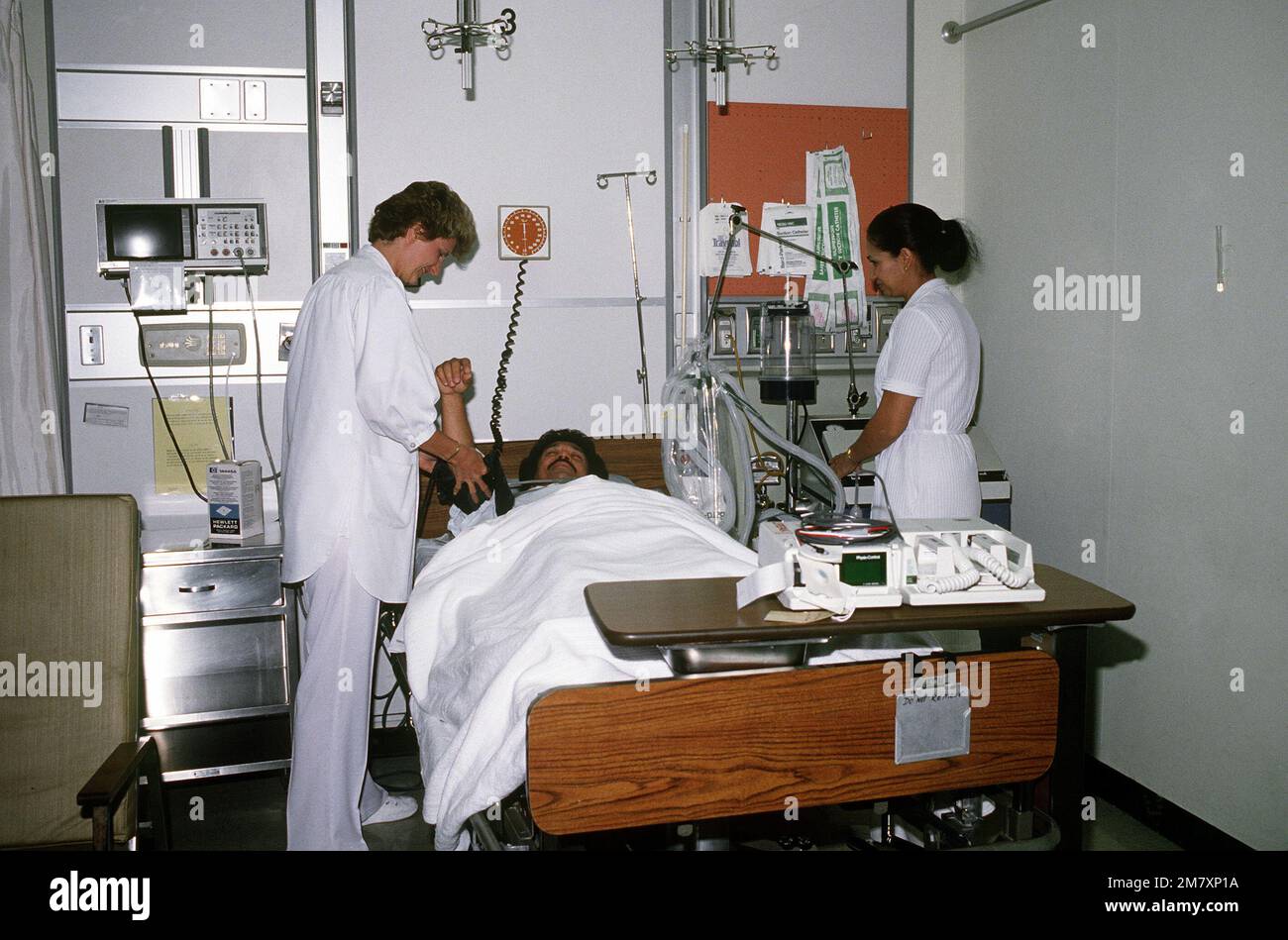 Bird Angermuller, a registered nurse, checks the blood pressure of a ...