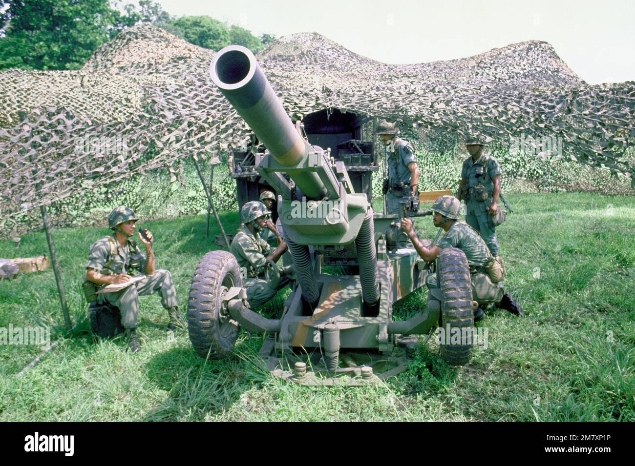 Members of Battery B, 22nd Field Artillery, prepare to fire an M-102 ...