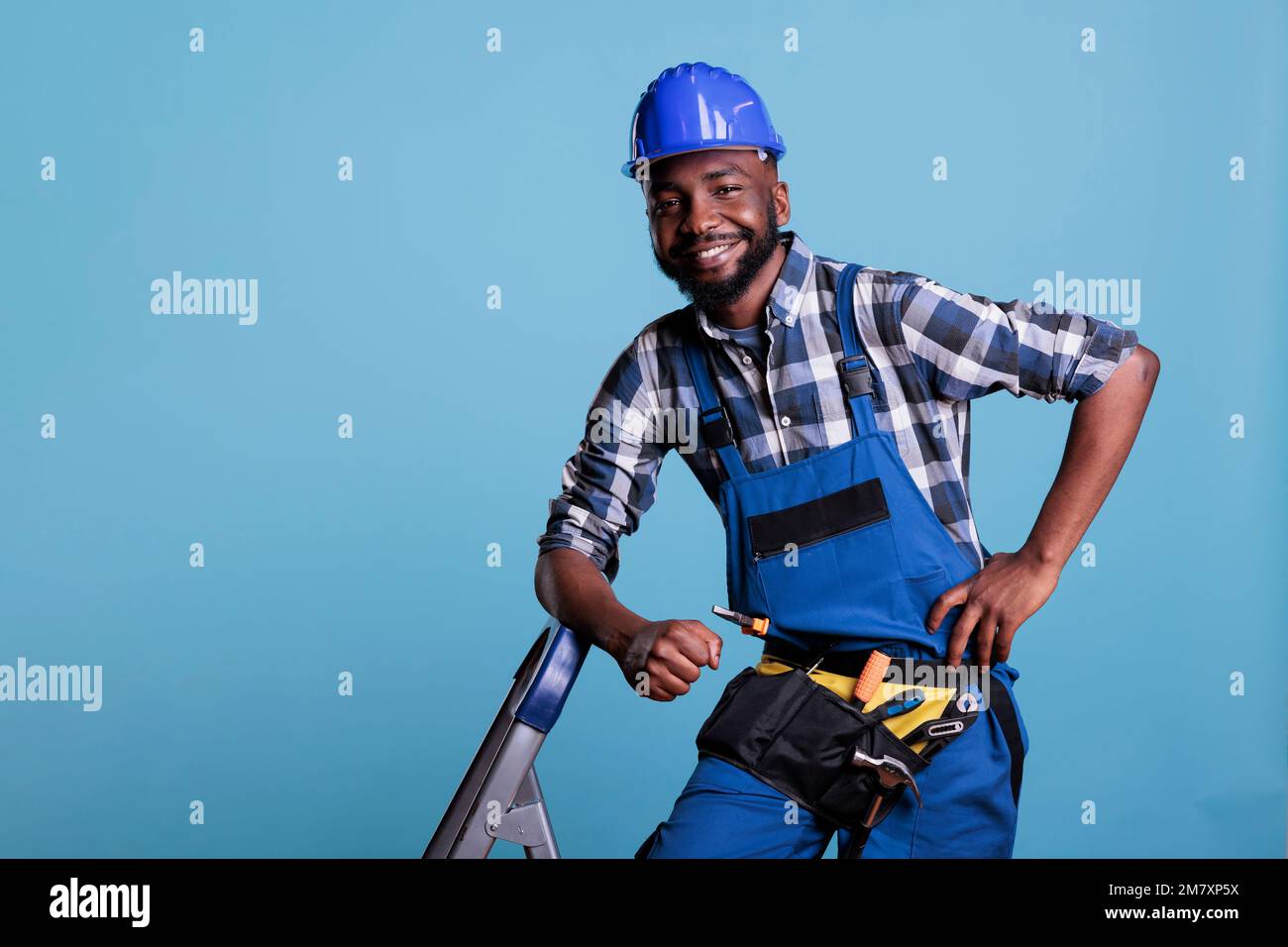 Builder looking happy and relaxed at work, dressed in coveralls and ...