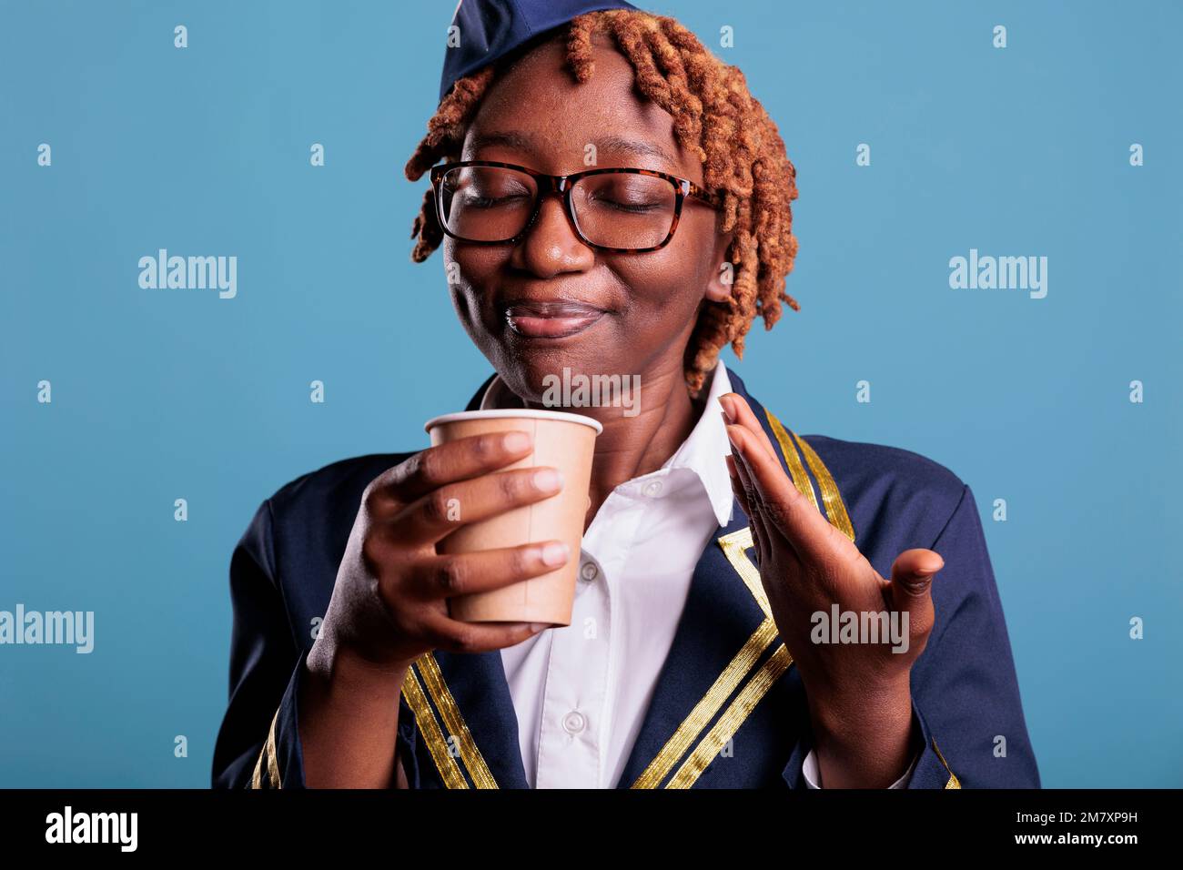 Professional female flight attendant delighted with scent of freshly ...