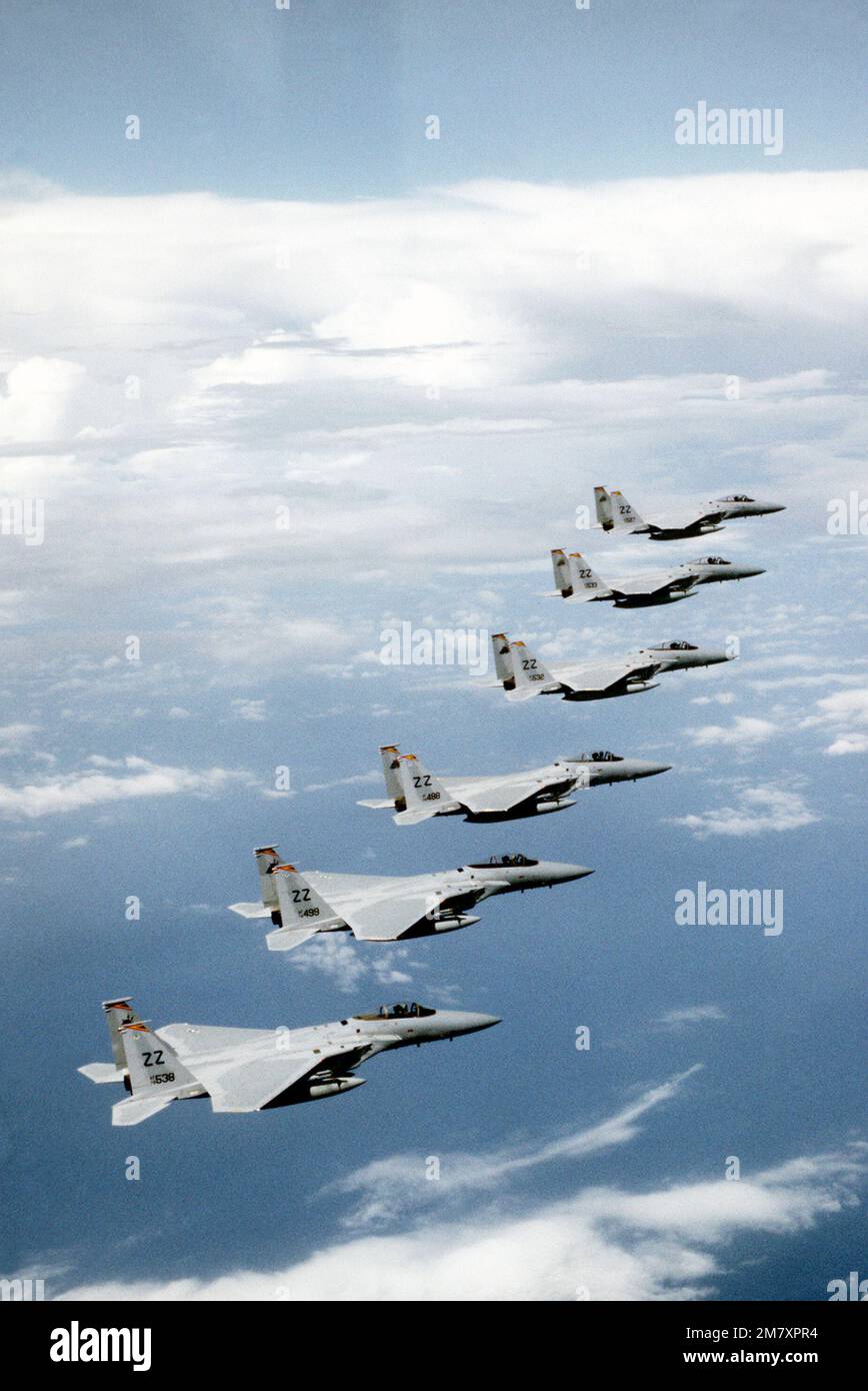 An air-to-air right side view of six F-15 Eagle aircraft flying in ...