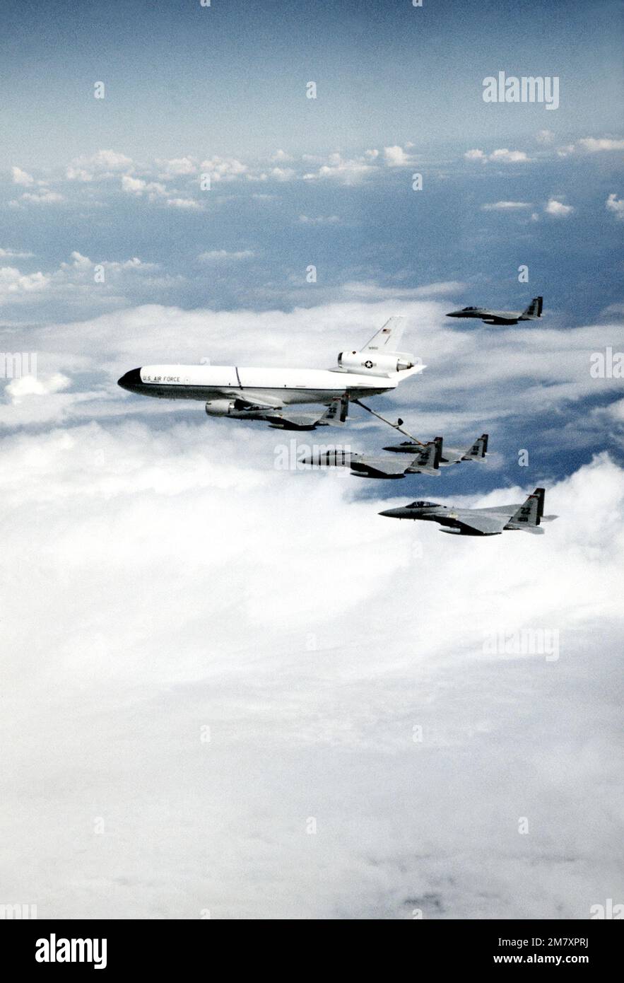 An air-to-air left side view of a KC-10A Extender aircraft flying in ...