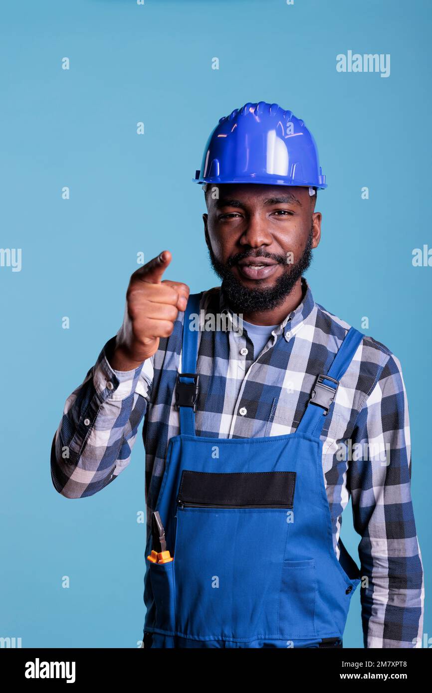 African american construction worker pointing index finger at camera ...