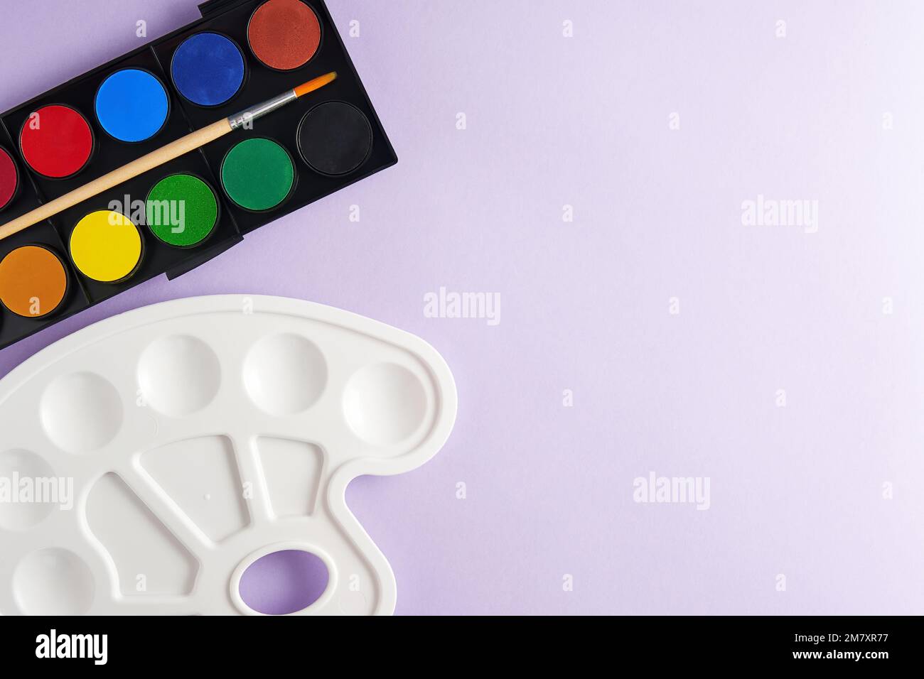 Banner with new watercolor paints, brush and plastic palette. Drawing ...