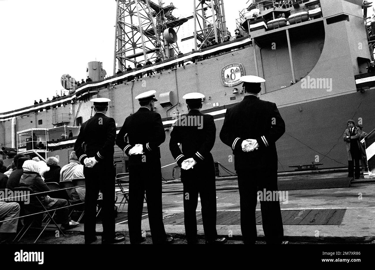 A rear view of four officers from the guided missile frigate USS AUBREY ...