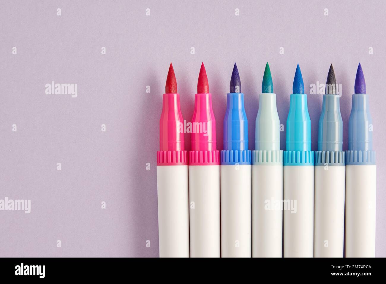 Opened pastel watercolor markers for sketching isolated on purple ...