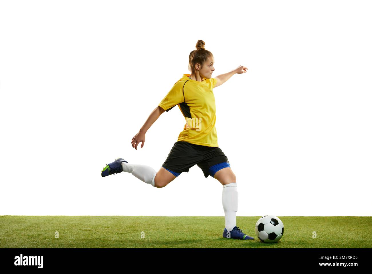 Young woman, professional female football player in motion, training ...