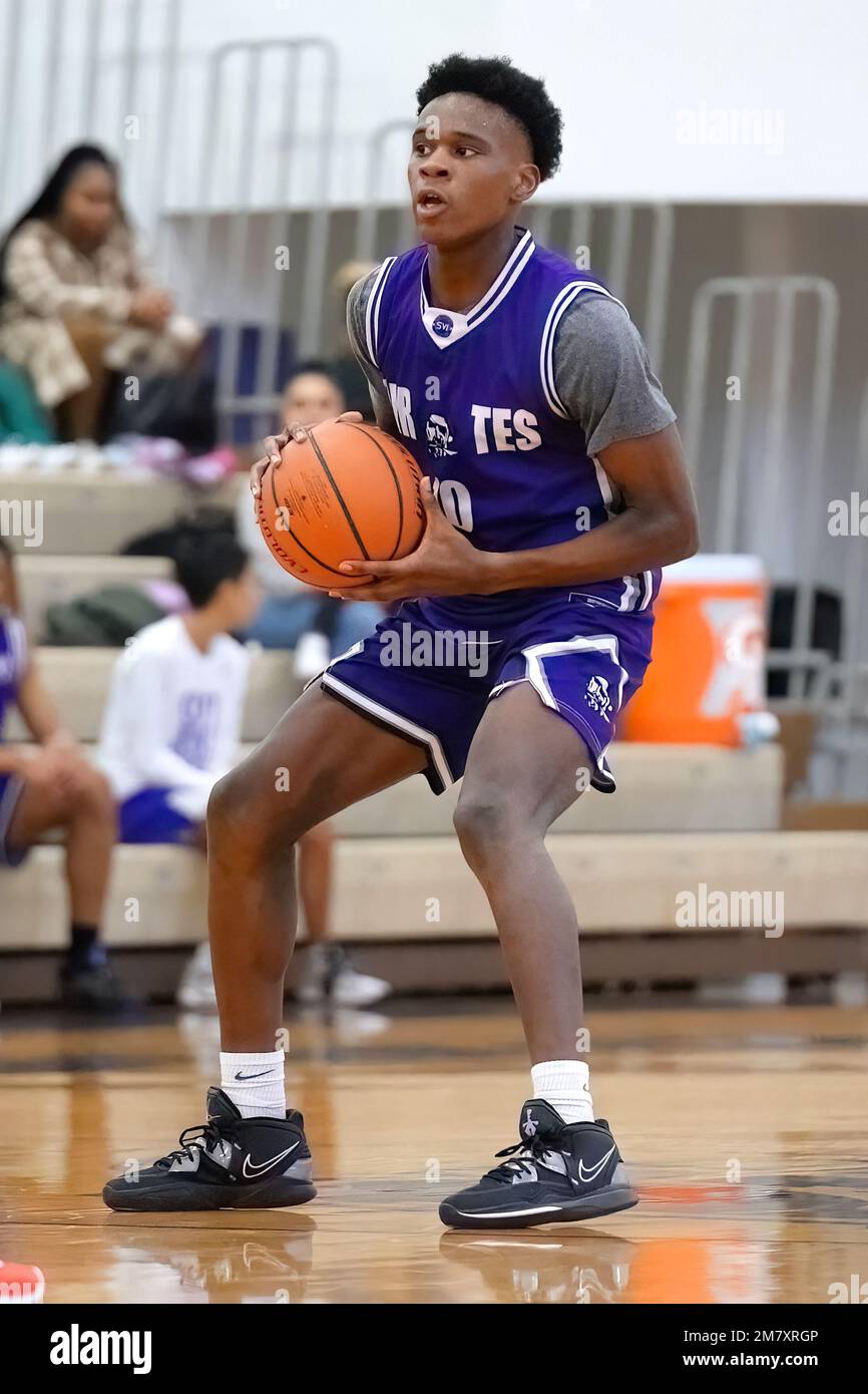 A young black basketball player in blue jersey dribbling the ball Stock ...