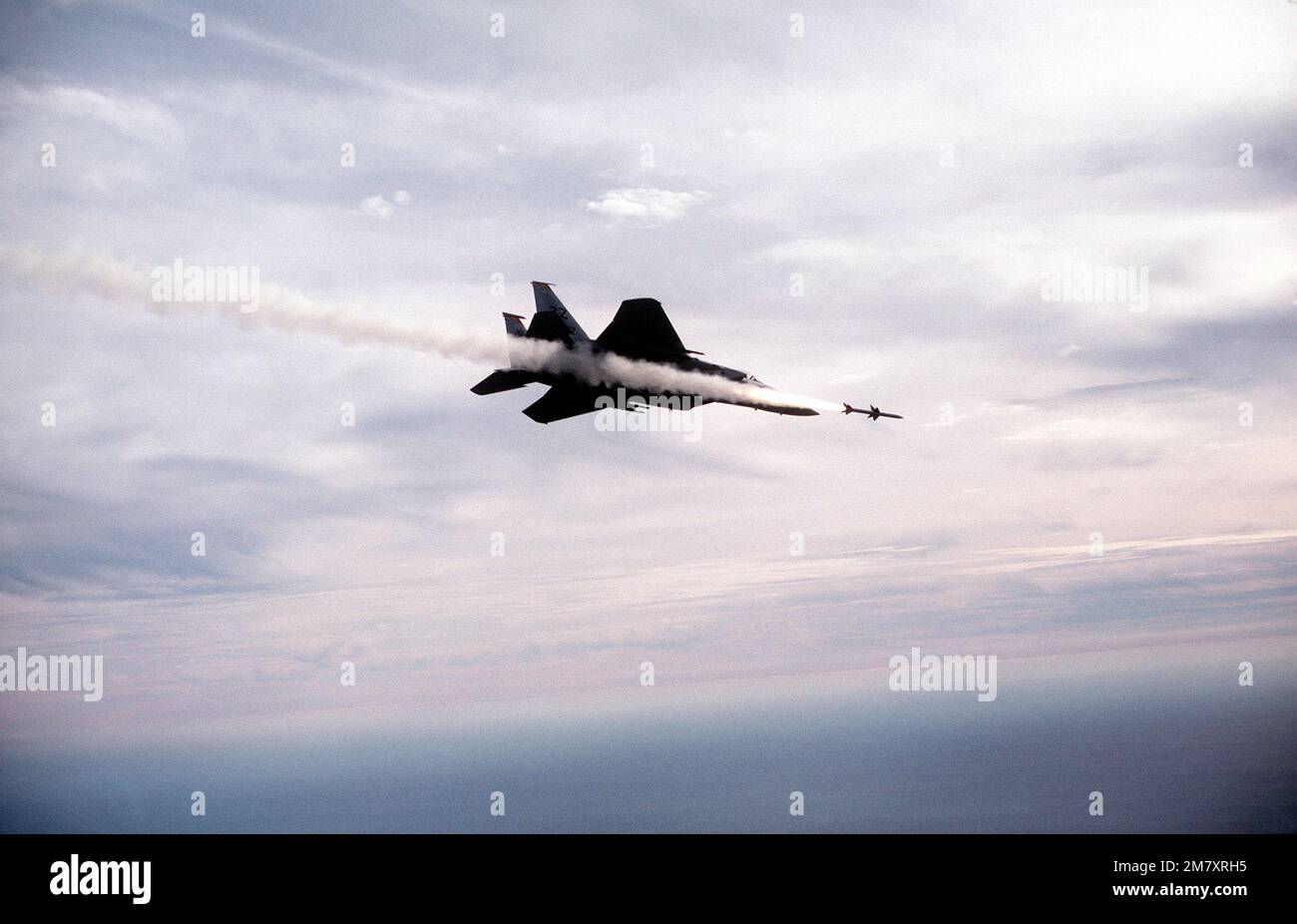 An air-to-air right side view of an F-15 Eagle aircraft firing an AIM-7 ...