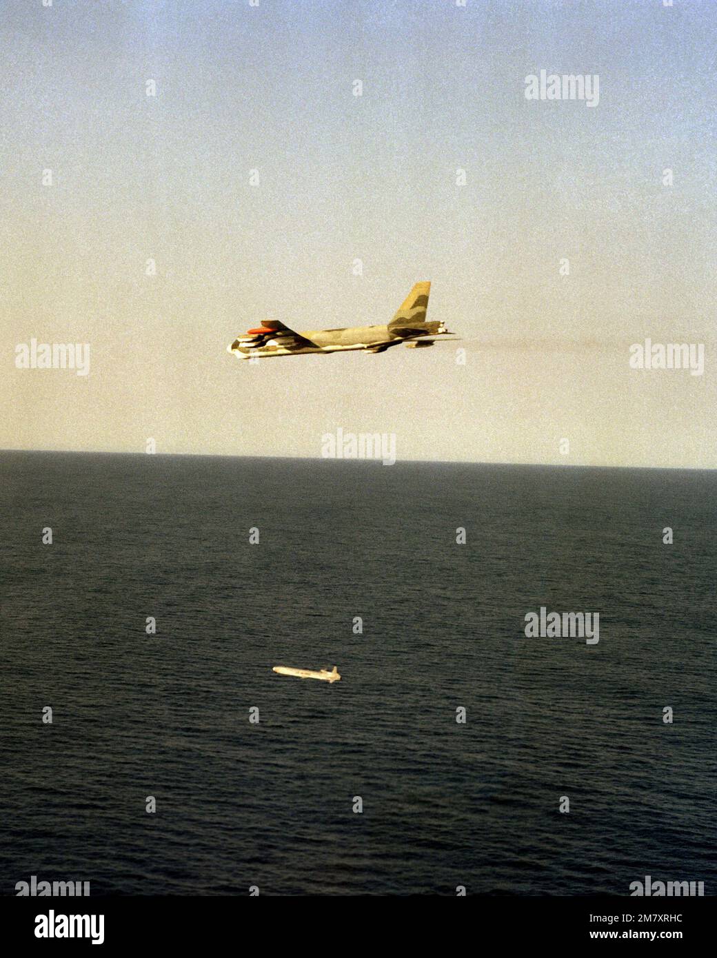 A left side view of a B-52 Stratofortress aircraft releasing an AGM-86 ...