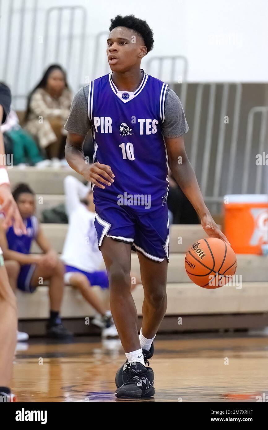 A young black basketball player in blue jersey dribbling the ball Stock ...