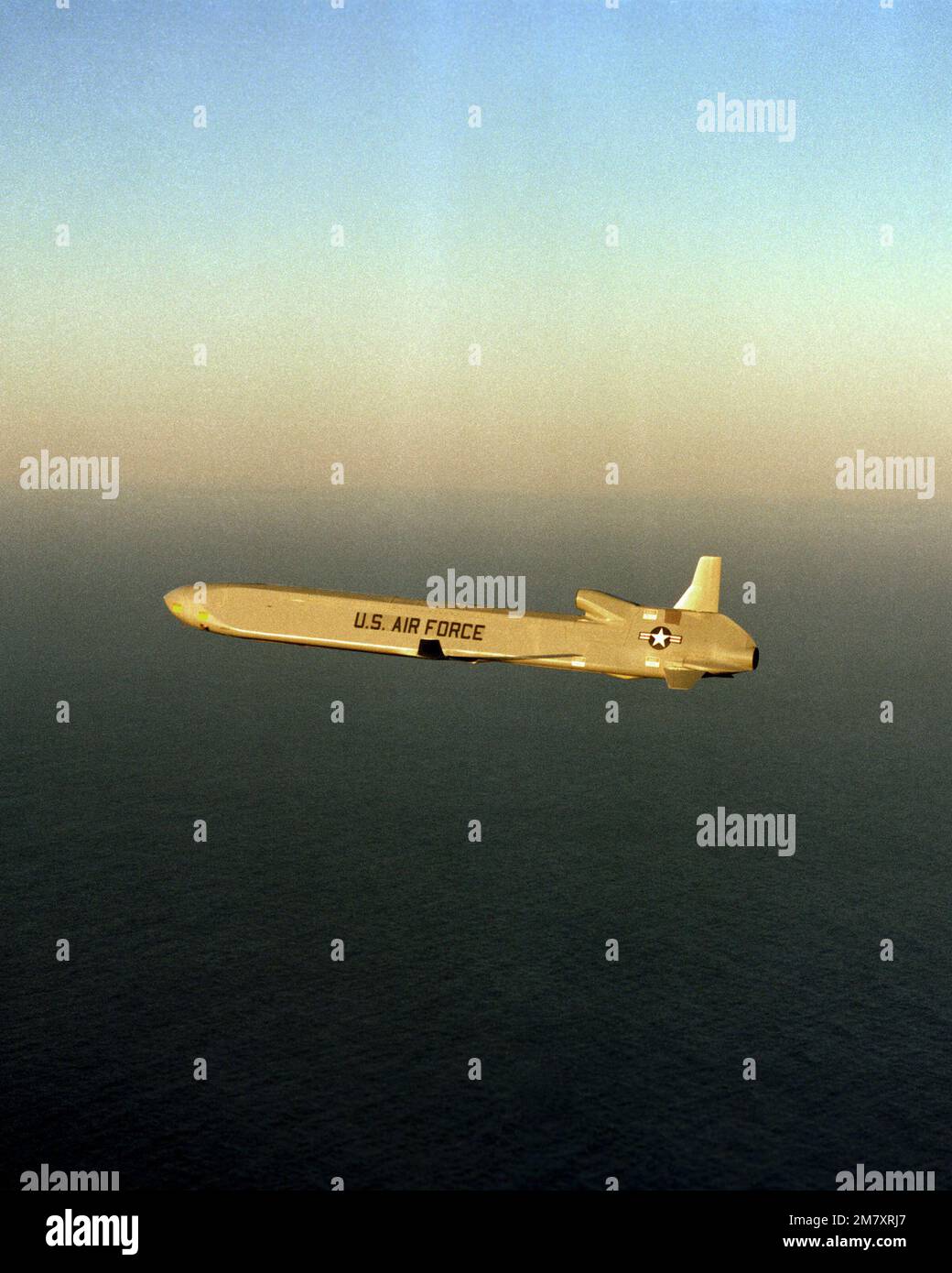 A left side view of an AGM-86 air-launched cruise missile in flight ...