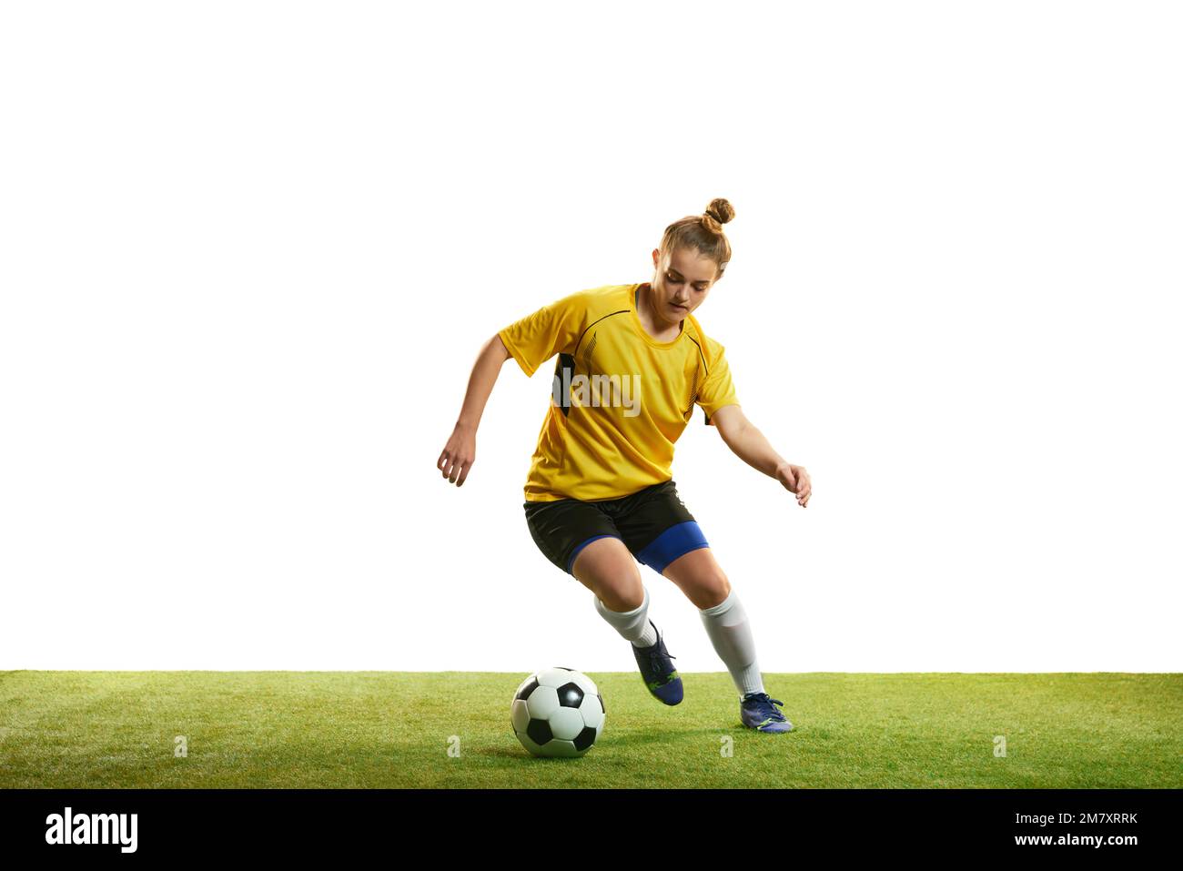 Dribbling. Concentrated young professional female football player in ...