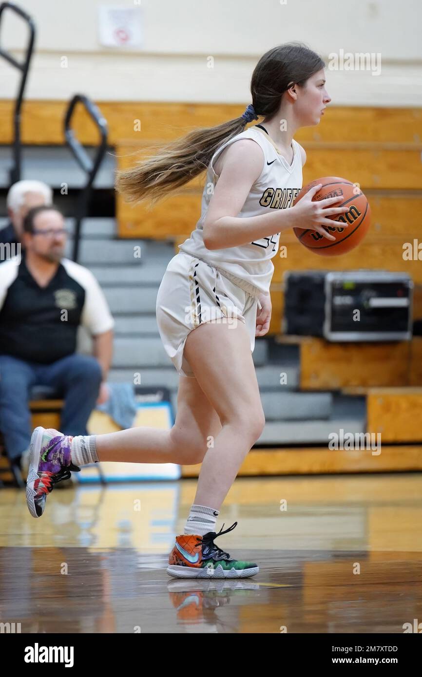 A vertical shot of a girl playing basketball during the girls fall high ...