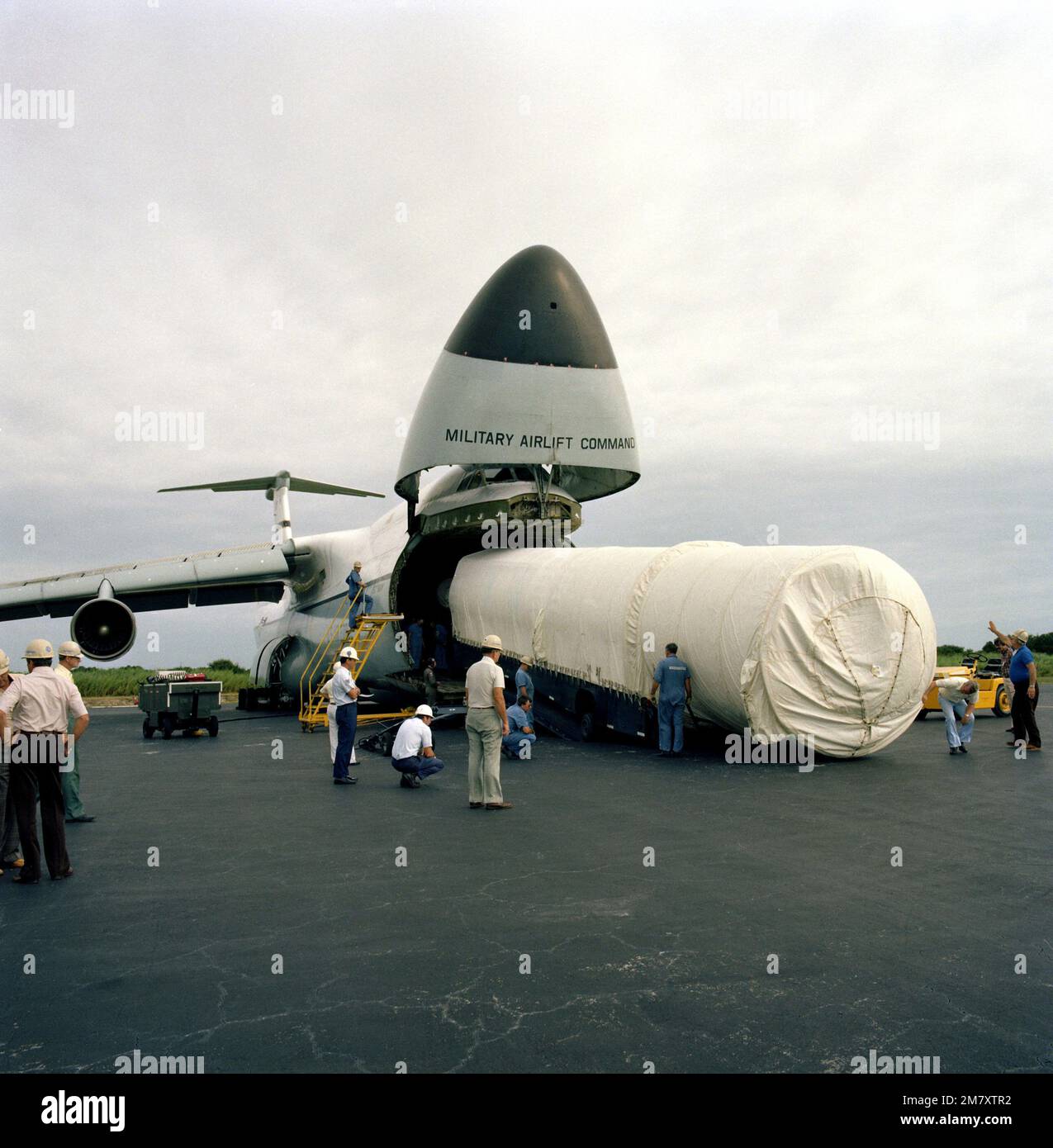 The D-10 and transport stage of a rocket are offloaded from the cargo ...