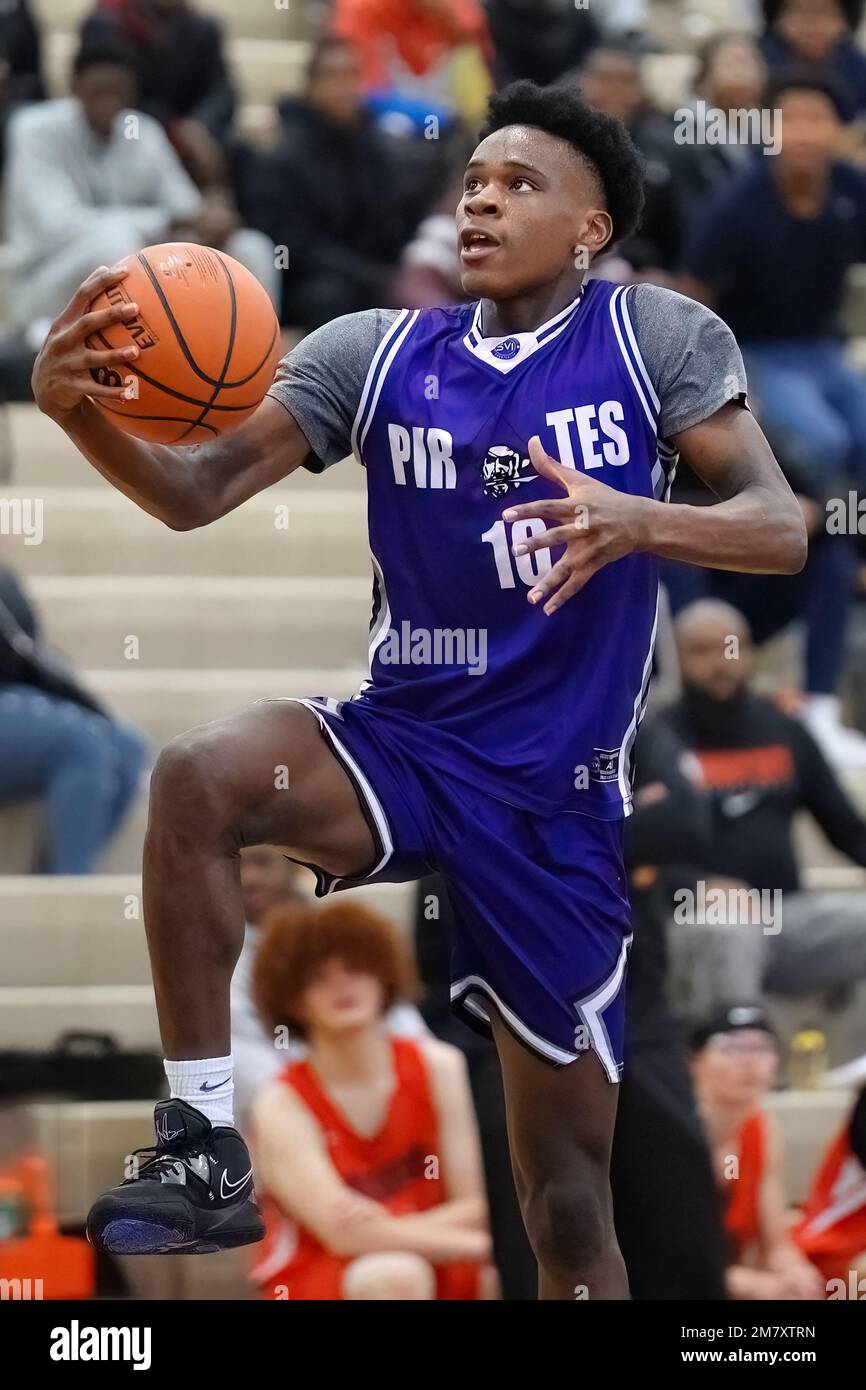 A young black basketball player in a blue jersey dunking the ball Stock ...