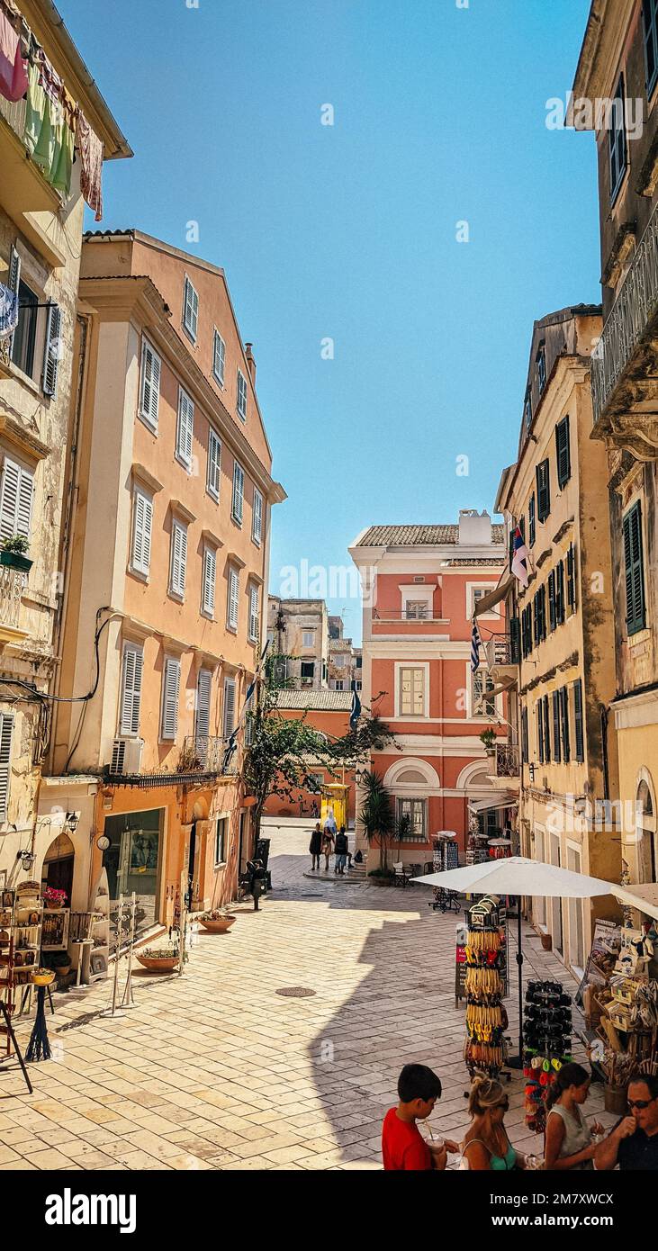 A vertical shot of cafes and old buildings at the Old Corfu City in ...