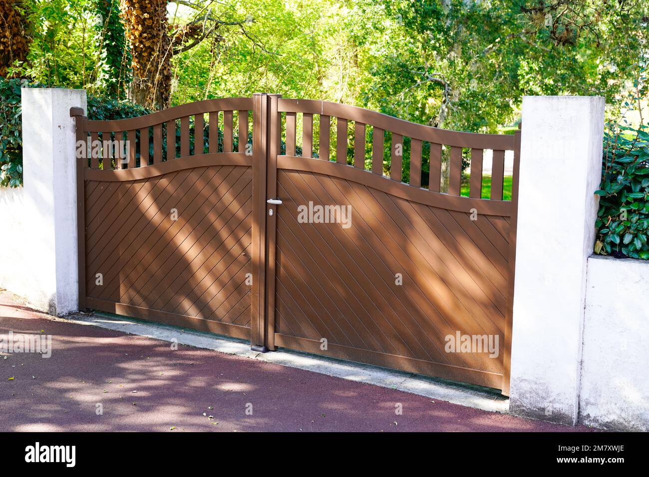 portal brown door metal aluminum house gate street view Stock Photo - Alamy