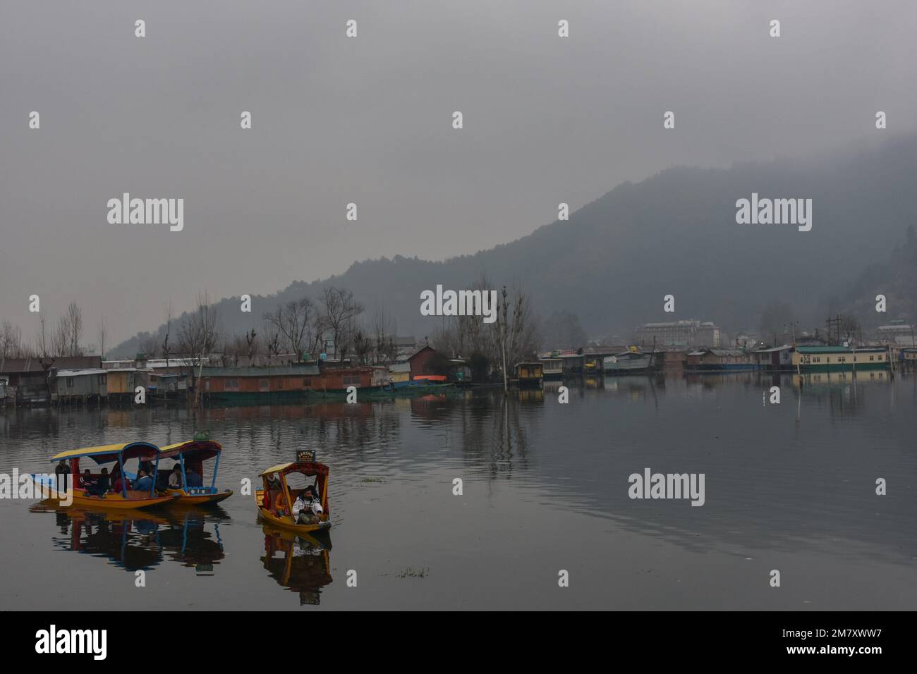 Srinagar, India. 11th Jan, 2023. Boatmen ferry tourists in their boats ...
