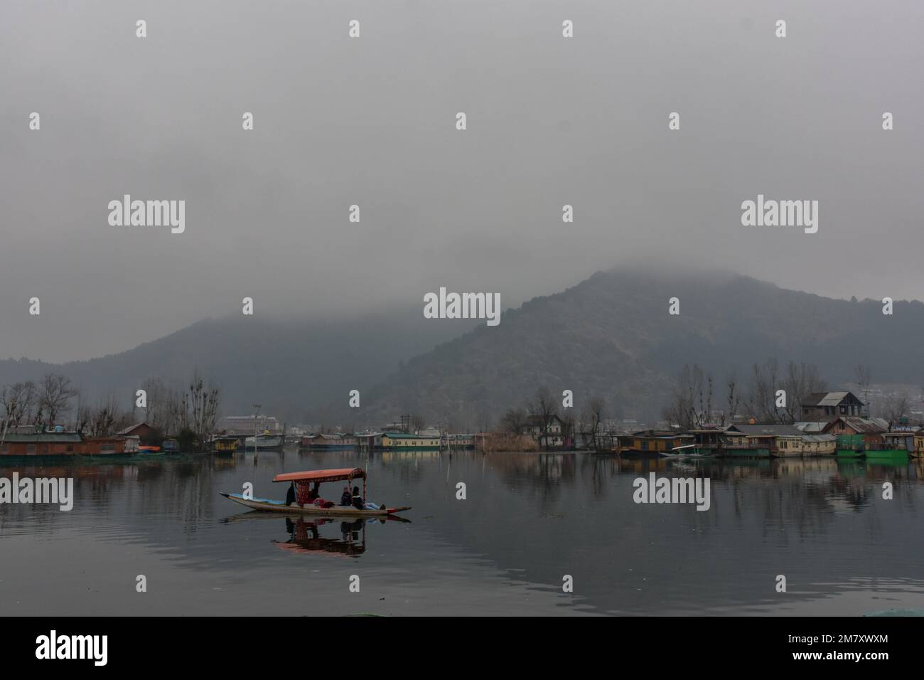 Srinagar, India. 11th Jan, 2023. A boatman ferries tourists in his boat ...