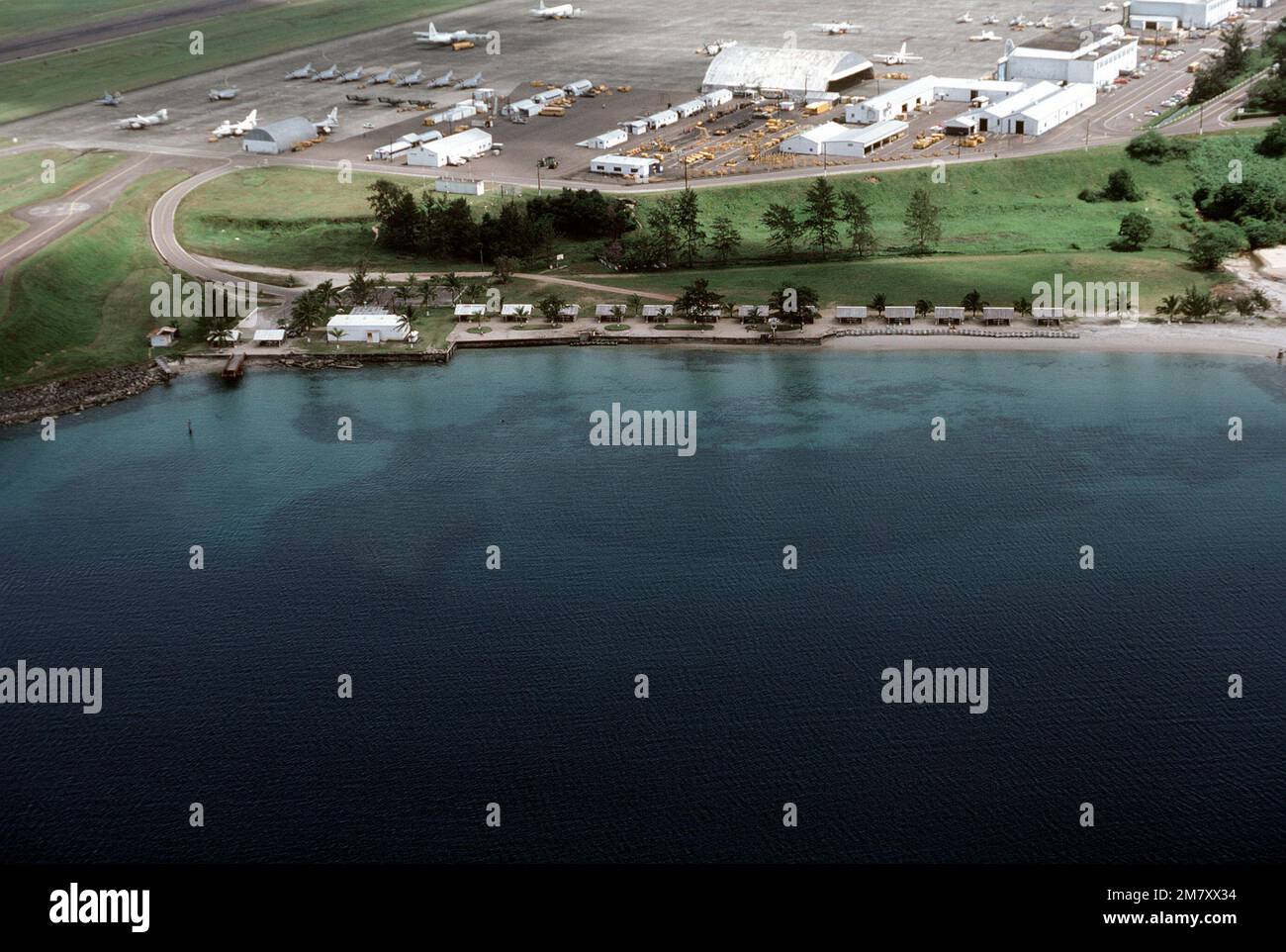 Aerial view of a facility, on the beach, and a hangar area. Base: Naval ...