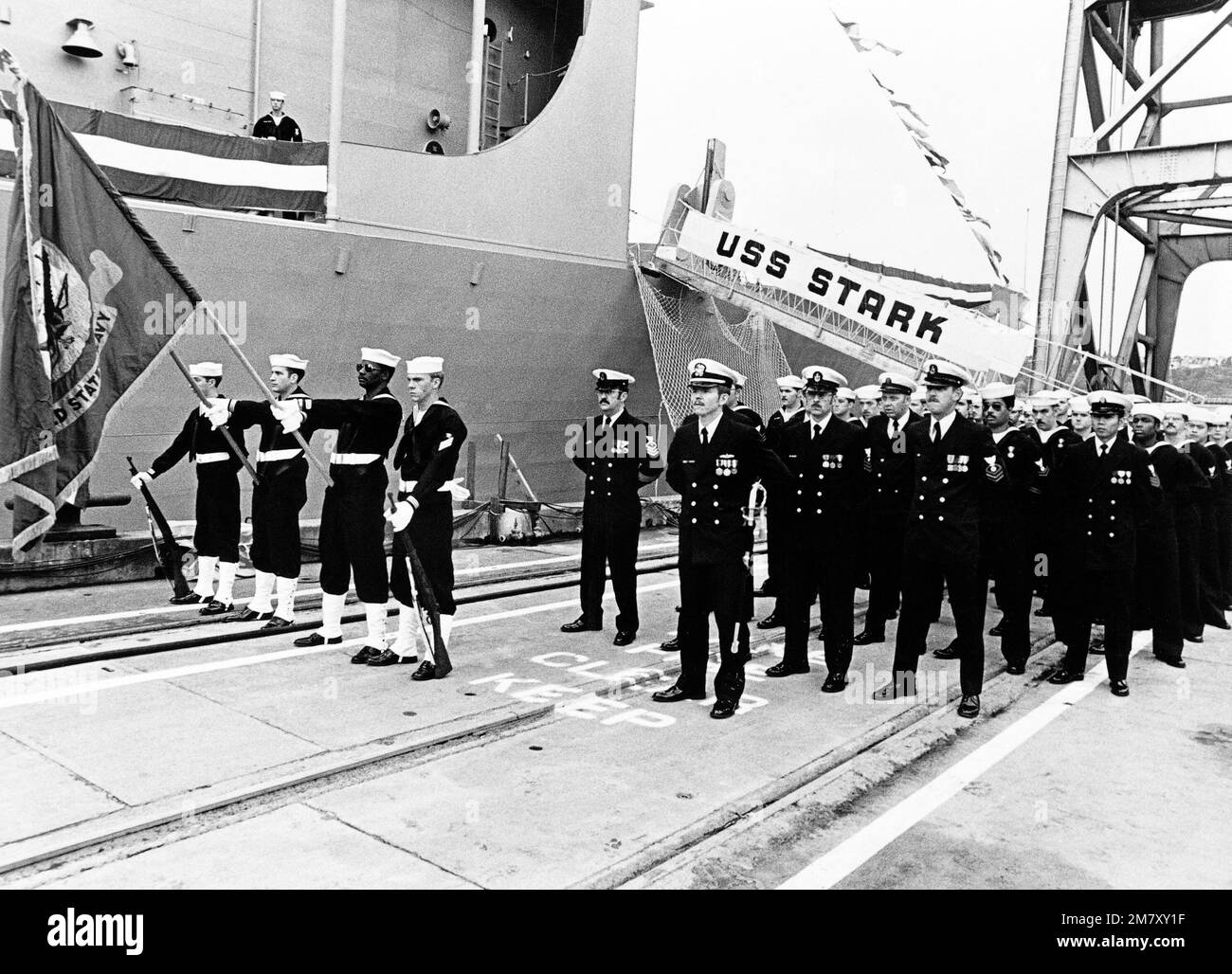 The ship's color guard and crew stand at parade rest during the ...