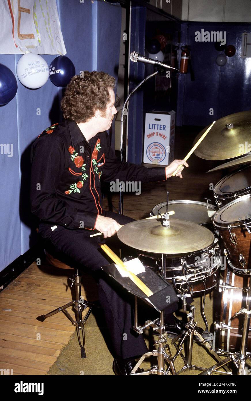 A member of the Lettermen Band entertains an audience at the USO show ...