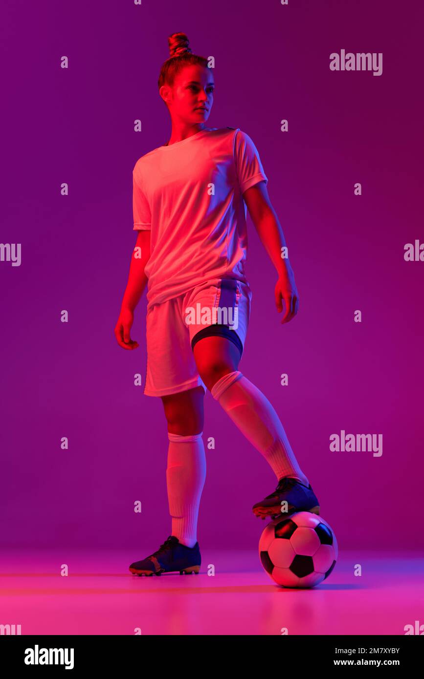 Young girl, professional female football, soccer player posing with ...