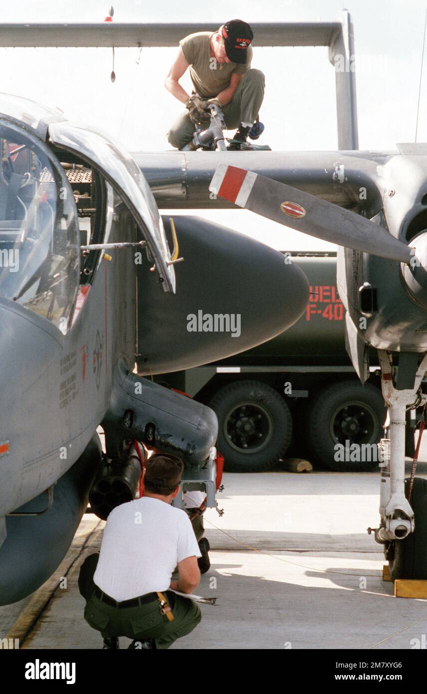 Members of the ground crew refuel and service an OV-10 Bronco aircraft ...