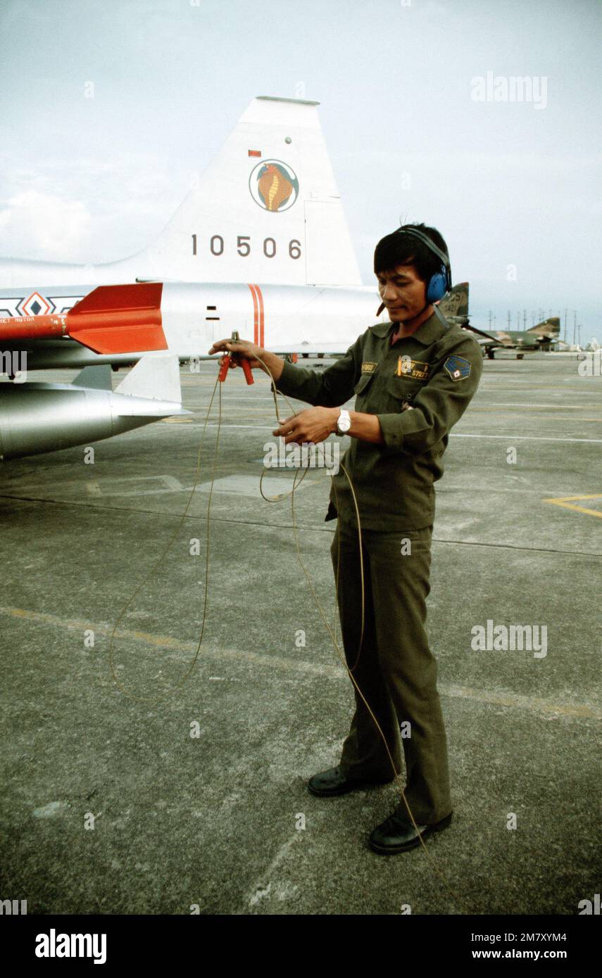 A Philippines Force ground crewman untangles a wire on the flight line ...
