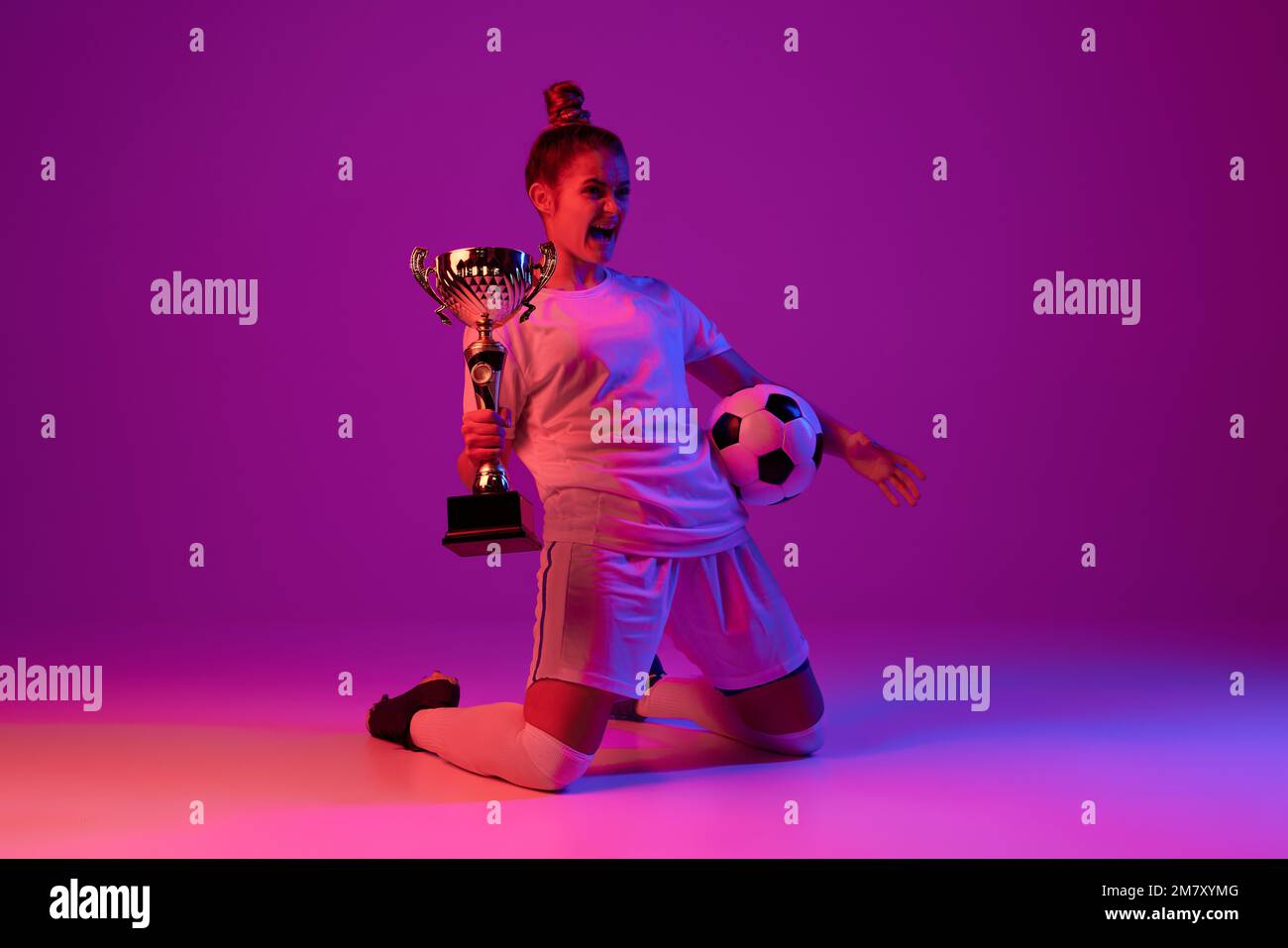 Young girl, professional female football, soccer player posing with ...