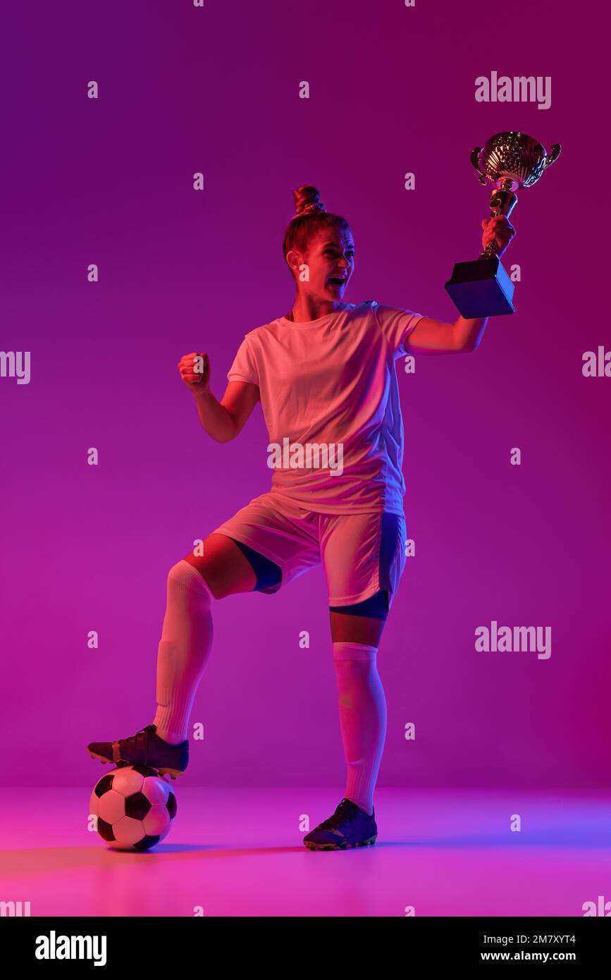 Young girl, professional female football, soccer player posing with ...