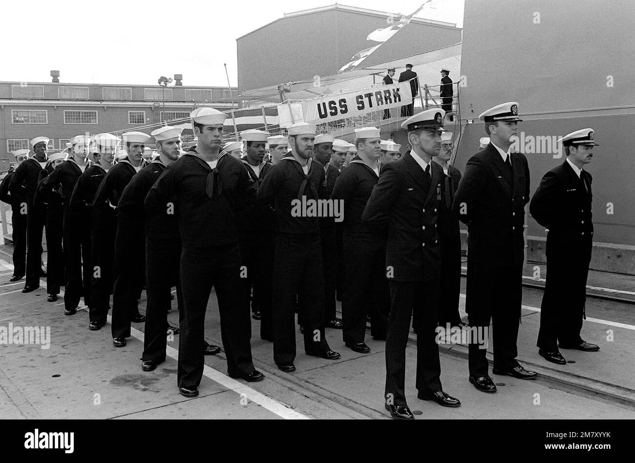 The crew of the guided missile frigate USS STARK (FFG-31) stand on the ...
