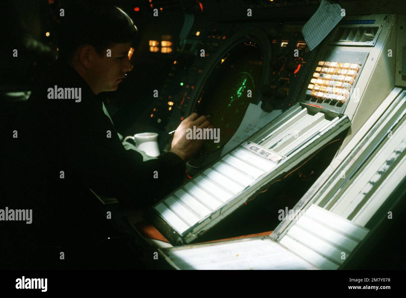 An air traffic controller monitors a radar scope at the Travis Air ...