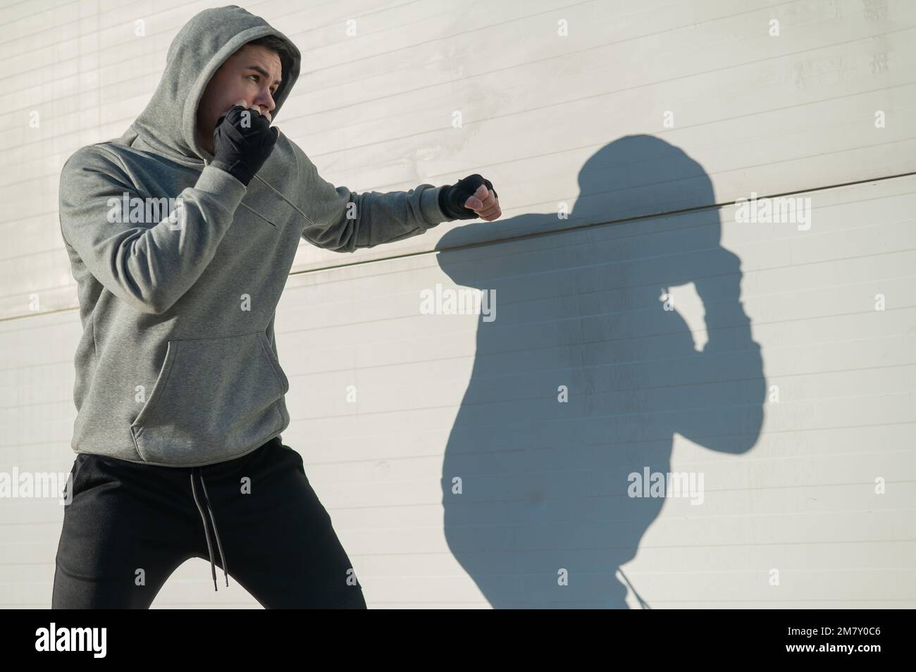 Portrait muscular man in hood hi-res stock photography and images - Alamy