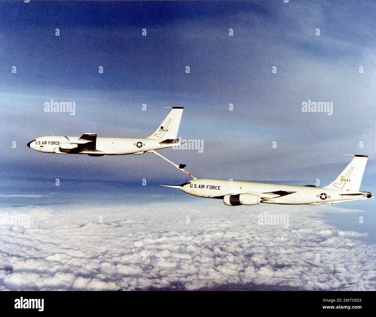 A left side aerial view of a KC-135A Stratotanker aircraft refueling a ...