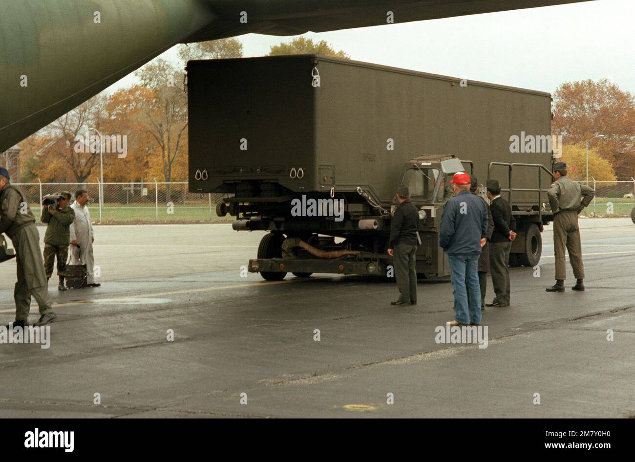 An XM-971E1 semi-trailer van is moved toward the loading ramp of a C ...